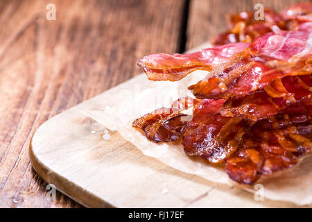 Bacon stripes (fried) with selective focus on wooden background Stock ...