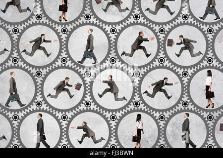 Businessmen running inside gears Stock Photo - Alamy