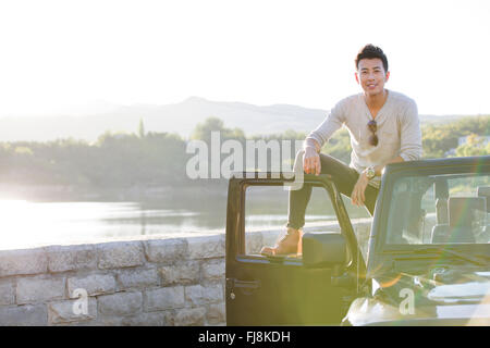 Young Chinese man and jeep Stock Photo - Alamy