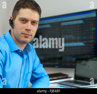 Handsome stock trader in front of computer Stock Photo - Alamy