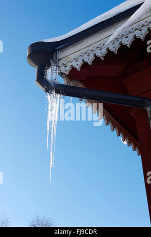Wall of icicles with snow Stock Photo - Alamy