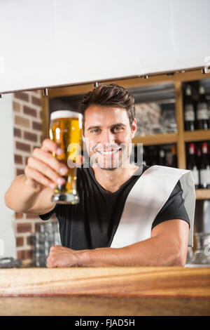 Handsome man holding his pint Stock Photo - Alamy