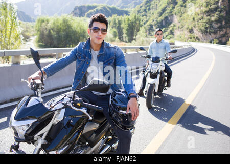 Young Chinese friends riding motorcycle together Stock Photo - Alamy
