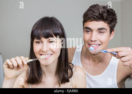 Happy Young brunette Couple Brushing Teeth In Bathroom, Loving Man and ...