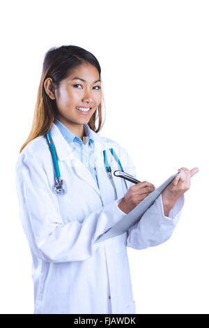 Asian woman doctor writing medical notes in notebook studying with ...