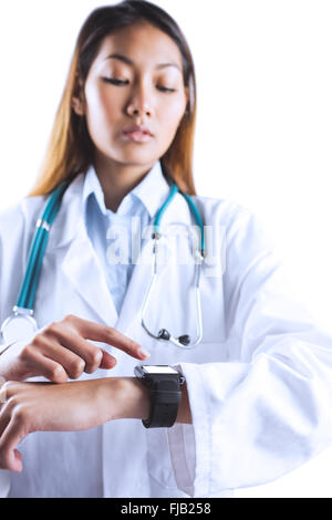 Asian doctor using her smart watch Stock Photo - Alamy