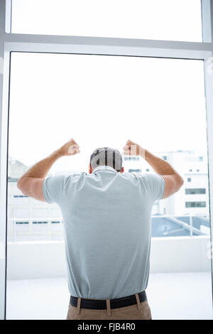 Tensed man leaning on glass window Stock Photo - Alamy