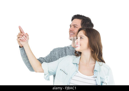 Couple embracing and pointing up Stock Photo - Alamy