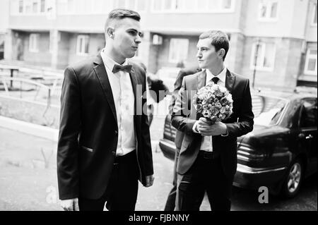 Groom with groomsman background wedding cars Stock Photo - Alamy