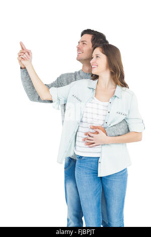 Couple embracing and pointing up Stock Photo - Alamy