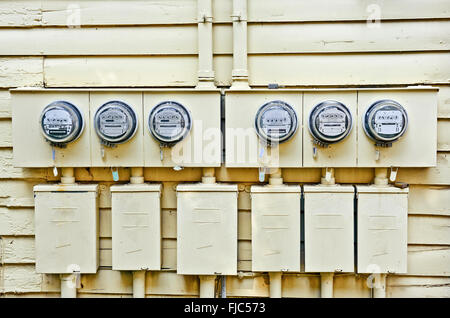 Domestic electricity meter on the exterior wall of an old abandoned ...