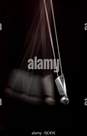 Hypnosis treatment tool swinging back and forth Stock Photo - Alamy