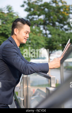 Chinese man with a tablet computer. Asian business man using digital ...