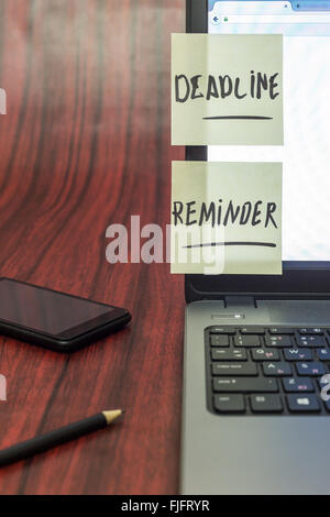 Two blank yellow notes sticked to a laptop display Stock Photo - Alamy