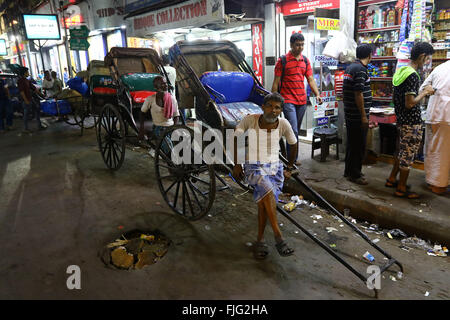 India, 19 February 2016. Hand pulling rickshaw puller pulling with ...