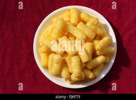 Cheetos is a crunchy corn puff snack. Bright orange cheese puffs in a ...