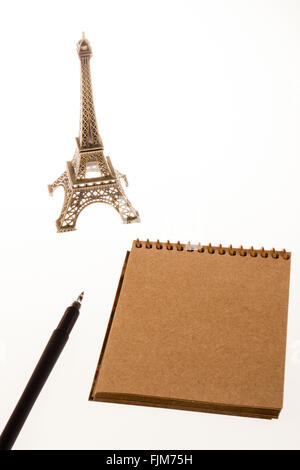 Notebook and pen with Eiffel Tower on the background Stock Photo - Alamy