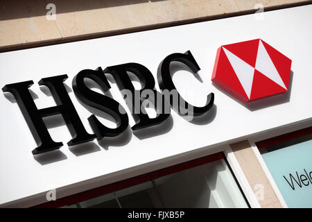 Facade of HSBC bank branch with red and white logo on concrete office ...