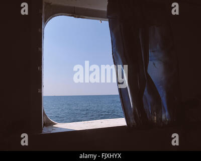 Seascape and sky through window Stock Photo - Alamy