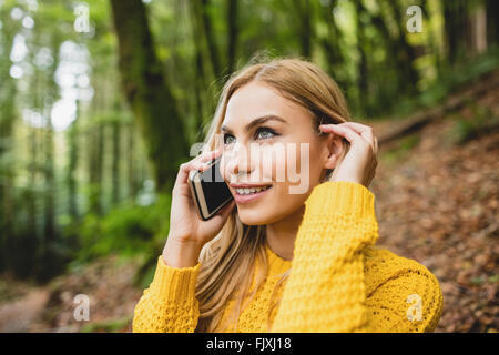 Young beautiful blonde woman calling and talking on smartphone over ...