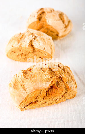 Three whole meal bread rolls with oat flakes on plate Stock Photo - Alamy