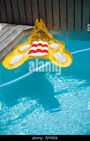 yellow inflatable lilo on swimming pool Stock Photo - Alamy