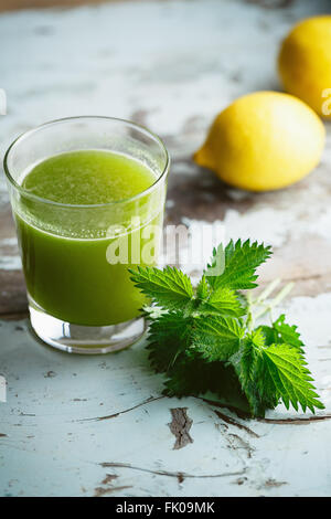 Fresh healthy nettle plant, lemon and dried herbs isolated on a white ...