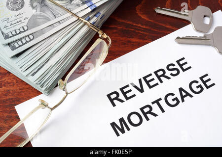 Reverse mortgage form on a table and money Stock Photo - Alamy