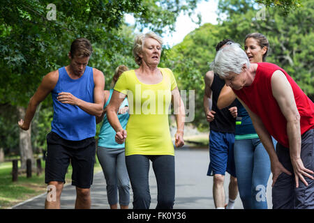 Exhausted male runners taking a break from training Stock Photo - Alamy
