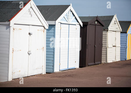 Right side view of beach huts with the blue sky and pebble beach in the ...