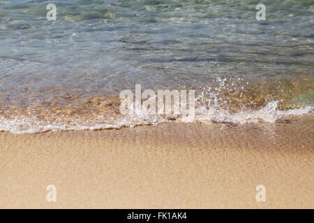 Closeup sea waves coming on beach at sunset light Stock Photo - Alamy