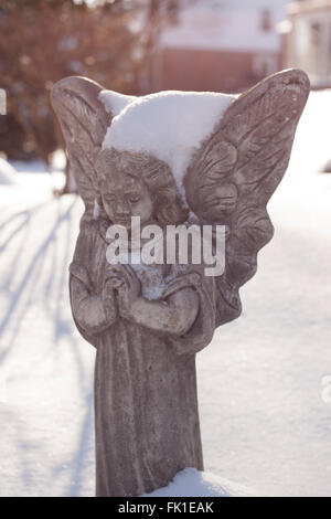 Snowy angel statue in the sunlight Stock Photo - Alamy