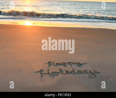 Holidays written in the sand on the beach Stock Photo - Alamy