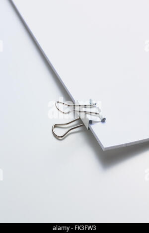 Alligator clip on paper Stock Photo - Alamy