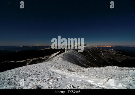 Full moon shining over snowy Pyrenees mountain range covered with snow ...