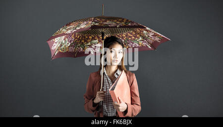 Businesswoman with an umbrella holding a binder Stock Photo - Alamy