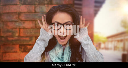 Composite image of asian woman shouting to the camera Stock Photo - Alamy