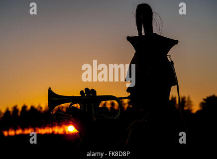 Silhouette of a man playing a bugle Stock Photo - Alamy
