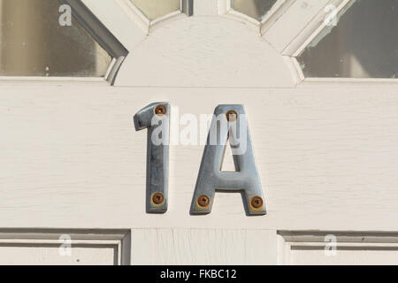 House number 1A sign on wall Stock Photo - Alamy