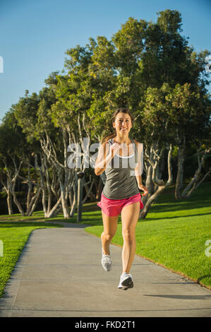 Woman running in a park Stock Photo - Alamy