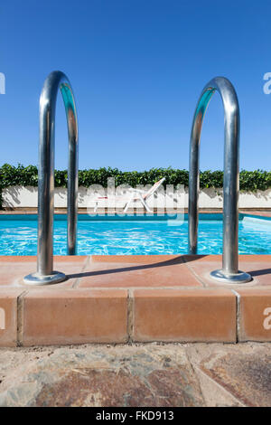 entrance to swimming pool with ivy on wall and blue sky Stock Photo - Alamy