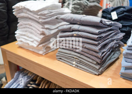 Stacks of clothes in store, close up view Stock Photo - Alamy