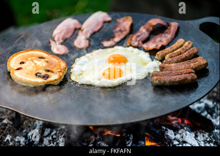Pancake breakfast with eggs, bacon, sausage, potatoes and orange juice ...