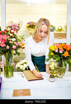 Beautiful young woman holding something over white background Stock ...