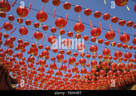 Red lanterns in the blue sky background Stock Photo - Alamy