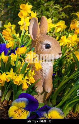 A Ceramic Rabbit placed amongst spring flowers Stock Photo - Alamy