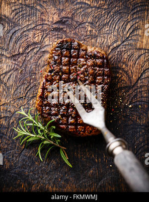 grilled meat with rosemary on a wooden board Stock Photo - Alamy