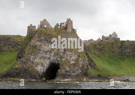 Sea cave under Dunluce Castle with Dunluce Castle viewed from the sea ...