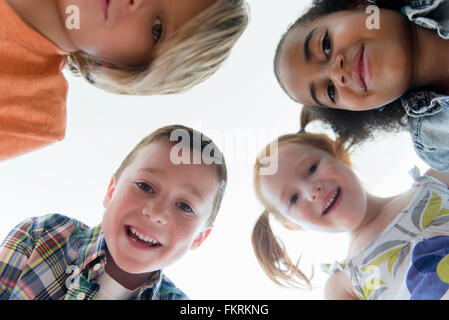 Low angle view of girls standing against window Stock Photo - Alamy