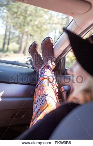 woman legs on car dashboard road trip highway Stock Photo - Alamy